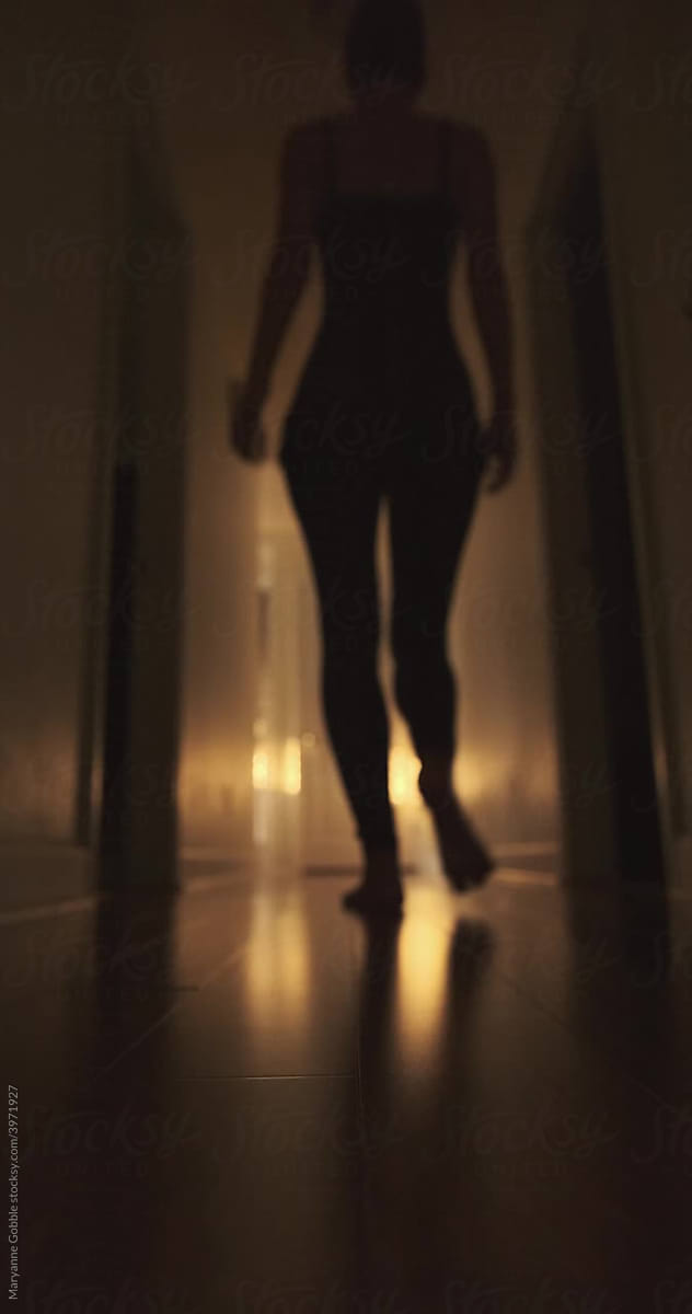 "Woman Walking Down Dark Hallway" by Stocksy Contributor "Maryanne ...