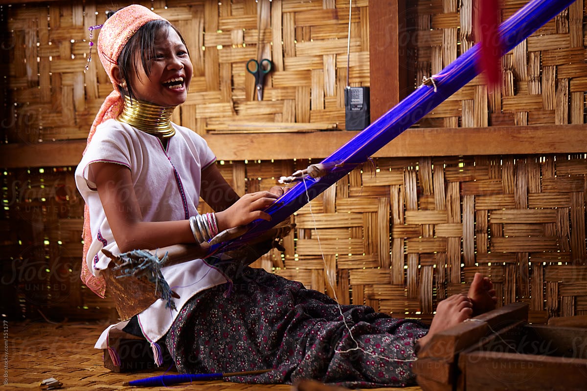 "Myanmar Long Neck Girl Weaving" by Stocksy Contributor "Bo Bo" - Stocksy