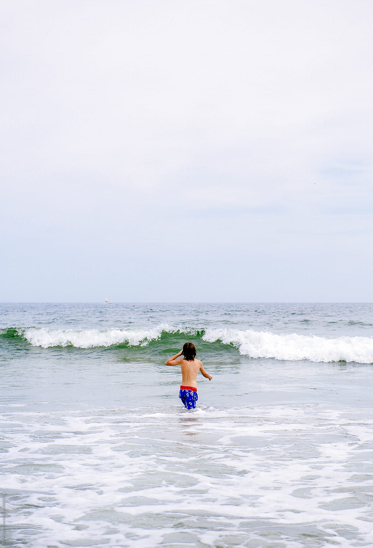"Boy Runs Into The Ocean" by Stocksy Contributor "Cara Dolan" - Stocksy