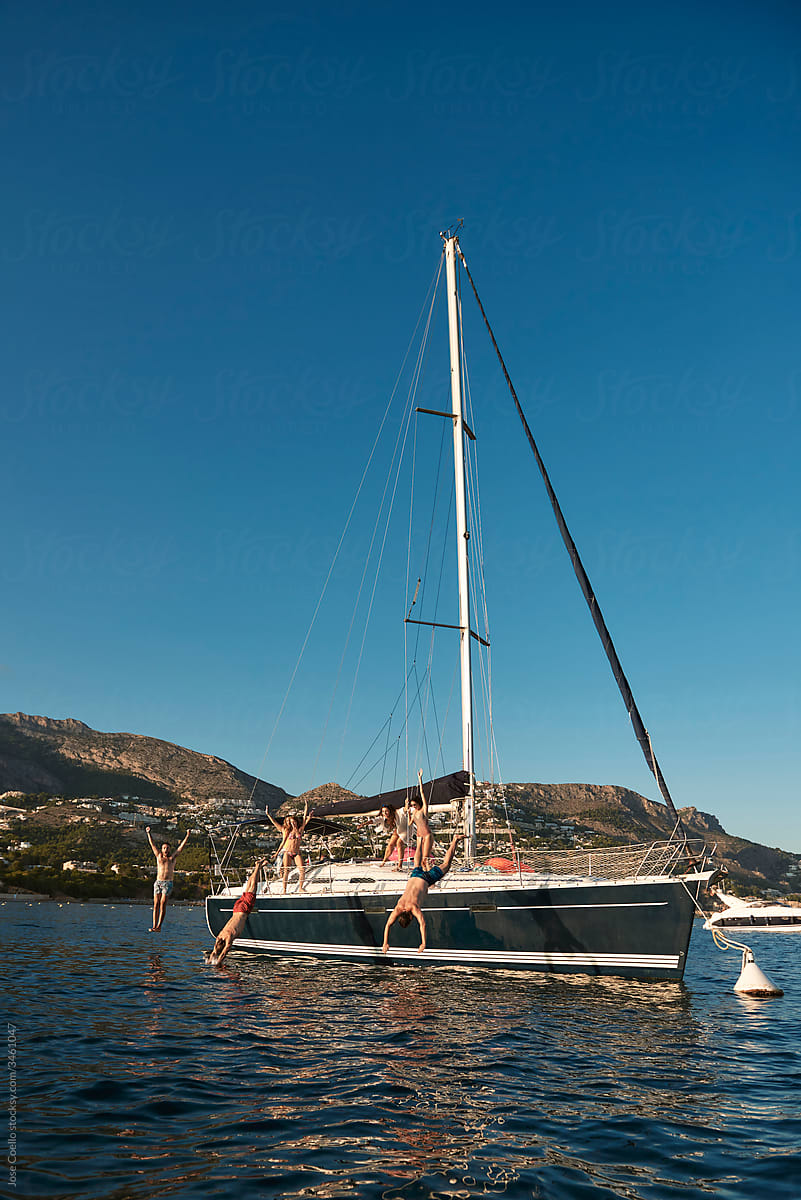 "Jumping From The Boat" by Stocksy Contributor "Jose Coello" - Stocksy