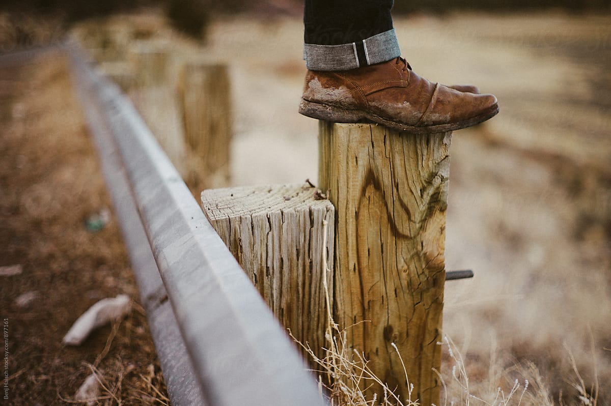 "Man Stands On A Guard Rail" by Stocksy Contributor "Benj Haisch" - Stocksy