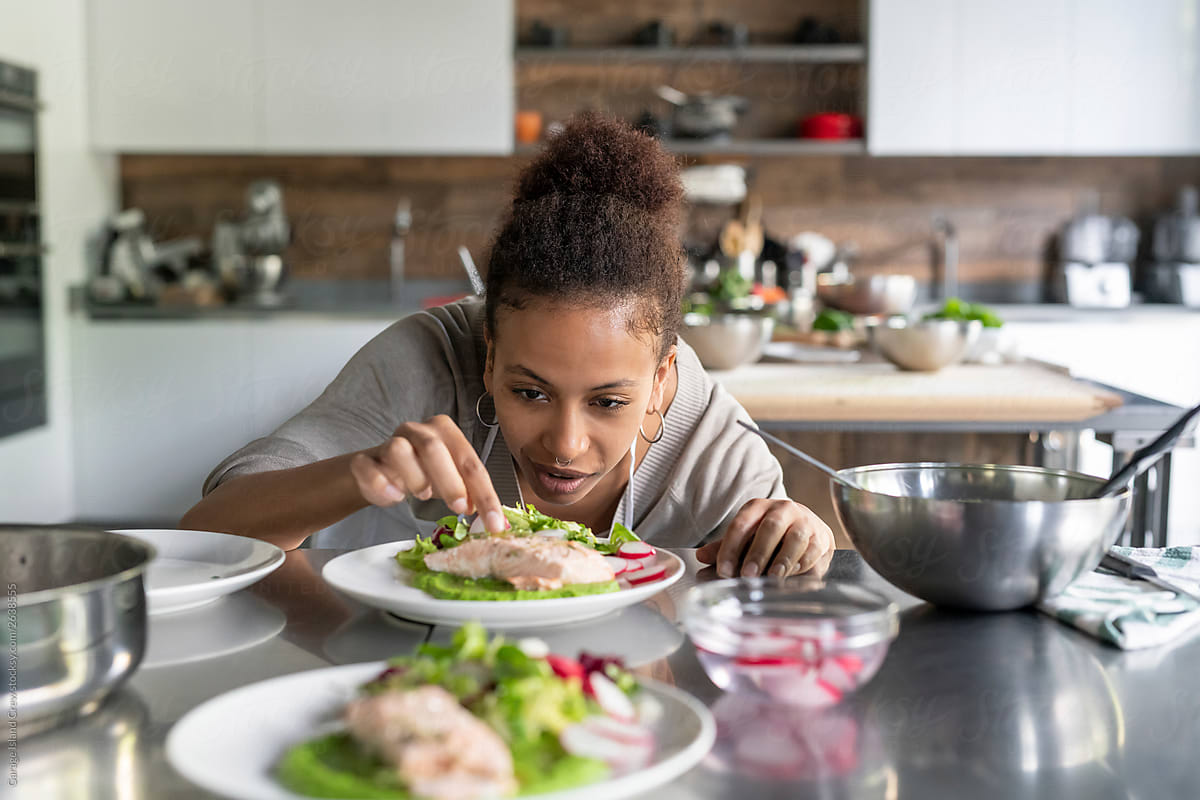 Woman cooking during a kitchen class - Stock Image - Everypixel