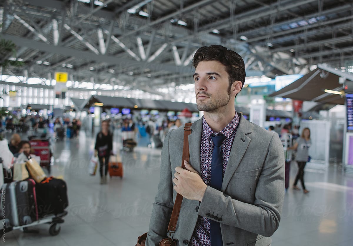 "Young Man With Bag Standing In The Airport Alone" by Stocksy ...