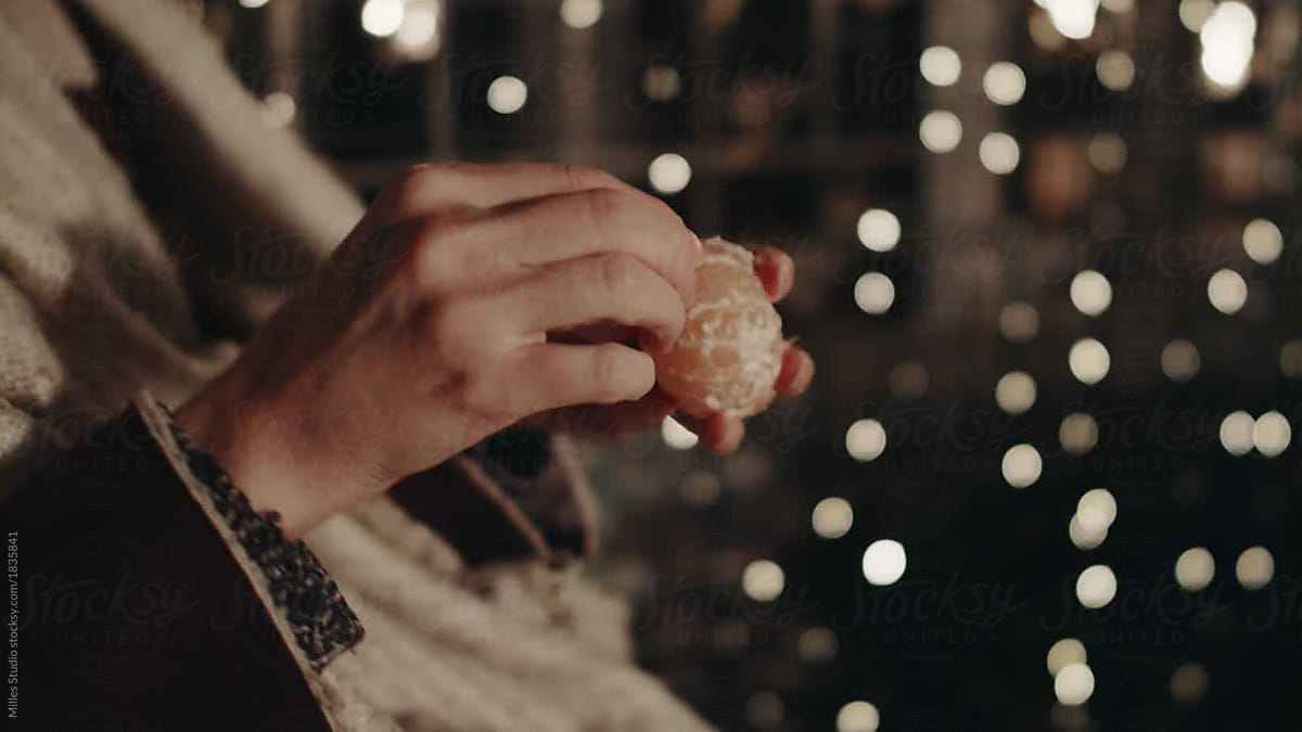 "Crop Woman Eating Tangerine In Lights" by Stocksy Contributor "Milles ...
