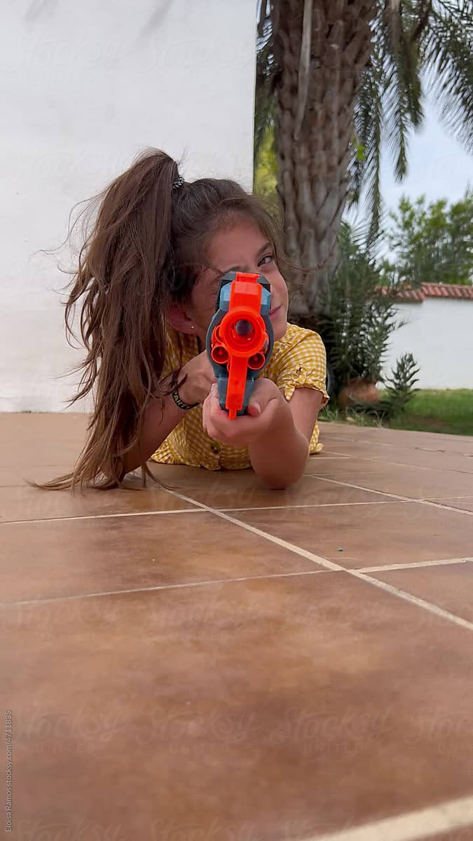 "UGC Kid Girl Shooting To Phone With A Toy Gun" by Stocksy Contributor ...
