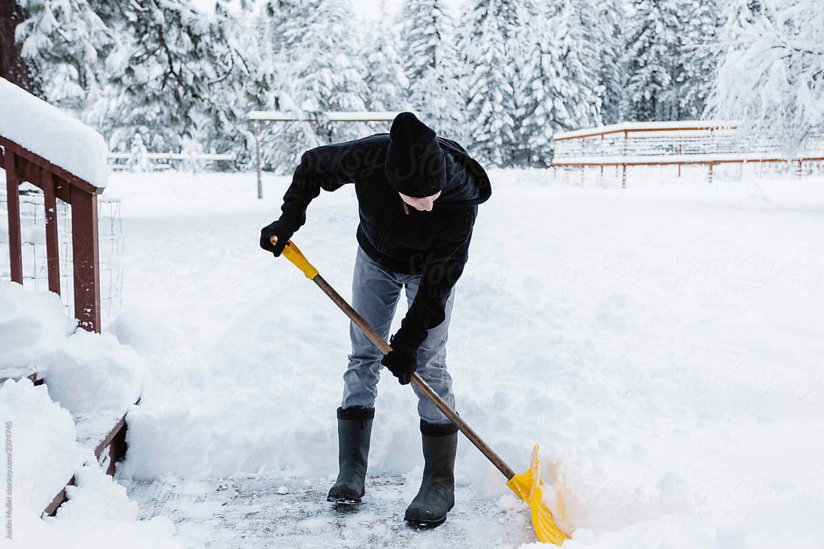 "Man Shoveling Snow" by Stocksy Contributor "Justin Mullet" - Stocksy