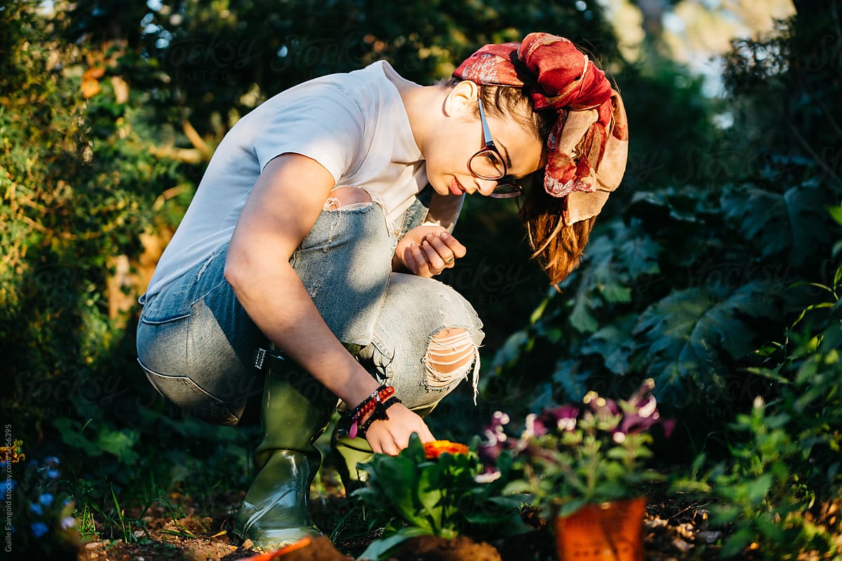 "Woman Growing Flowers In Garden." by Stocksy Contributor "Guille ...