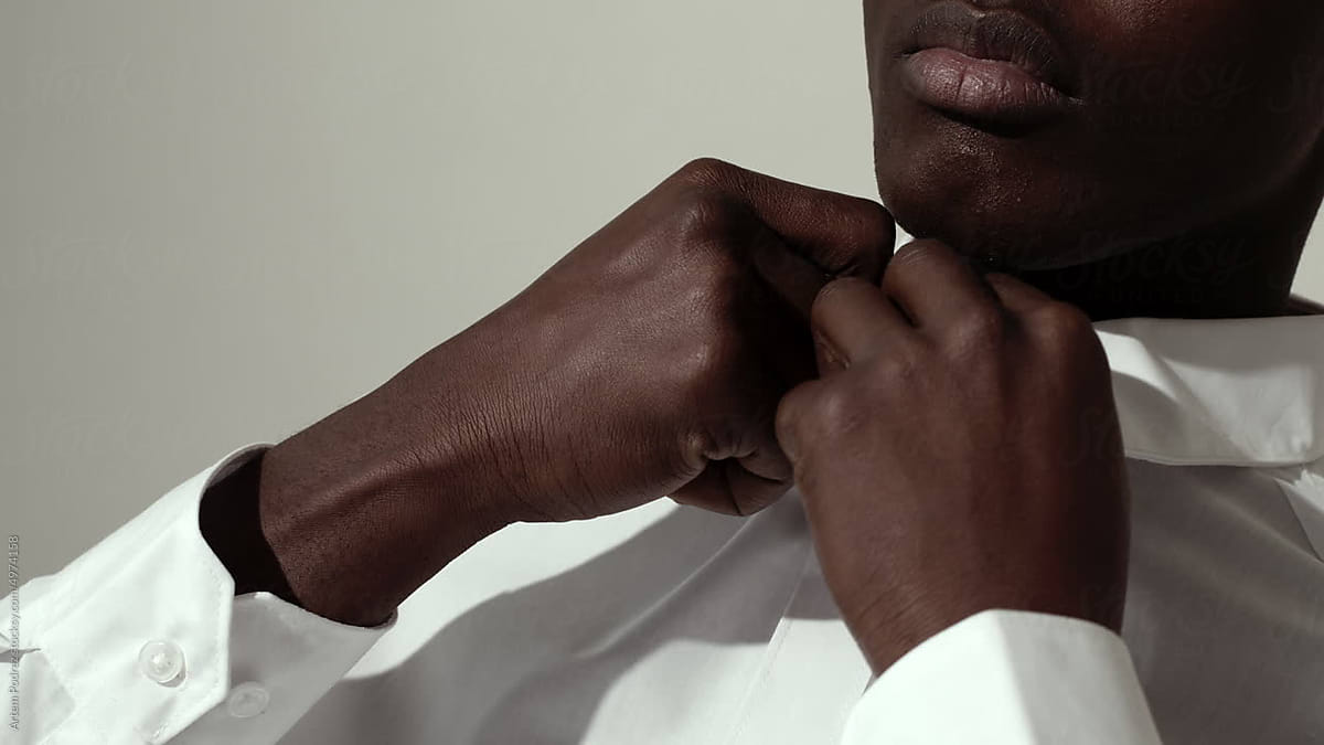 "The Man Buttons Up His Shirt" by Stocksy Contributor "Artem Podrez ...