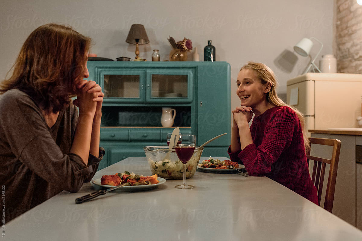 "Young Women Enjoying Dinner At Home" by Stocksy Contributor "Milles ...