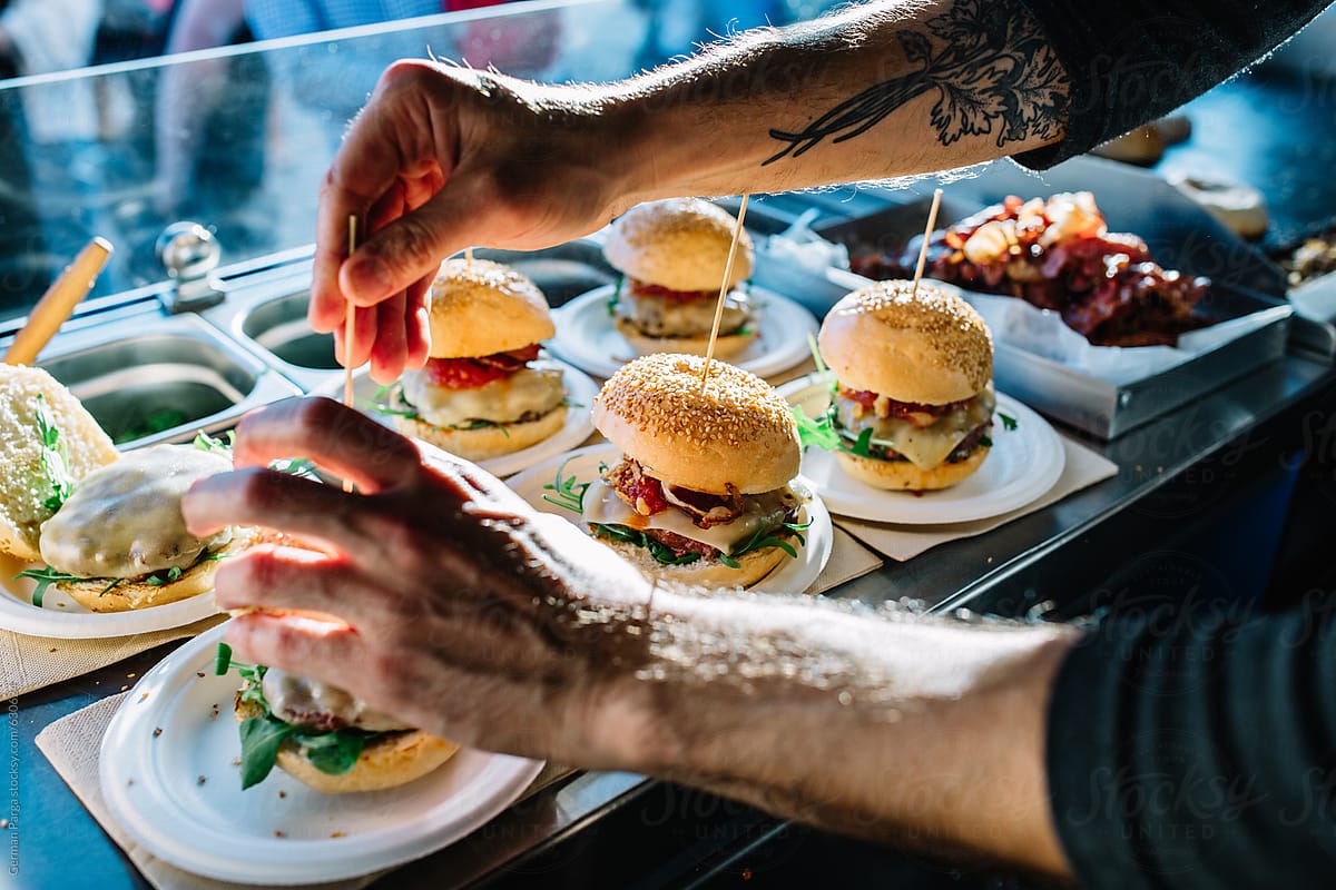 "Tattooed Arms Making Homemade Burgers" by Stocksy Contributor "Parga ...