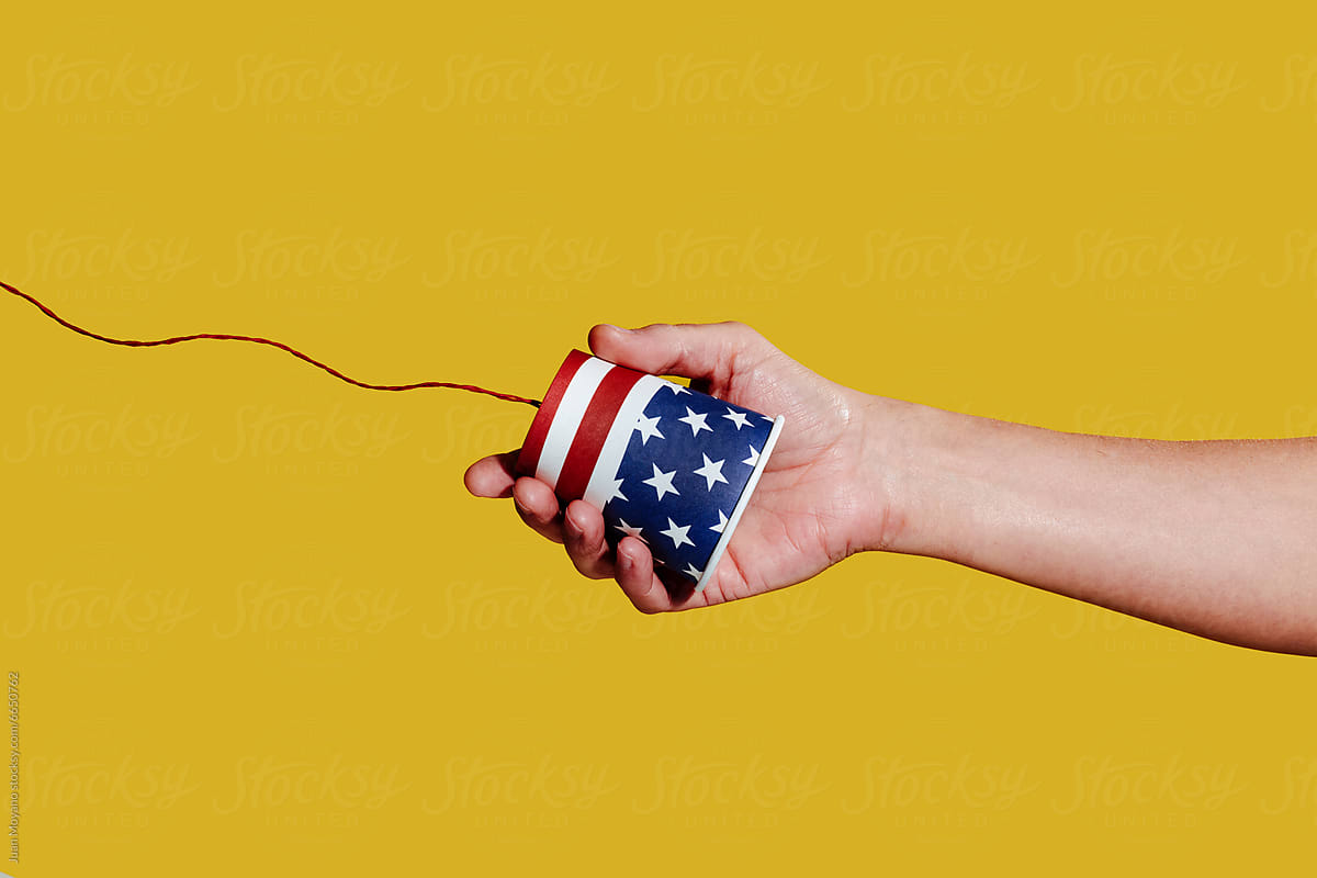 "Man Grabs An American String Telephone" by Stocksy Contributor "Juan ...