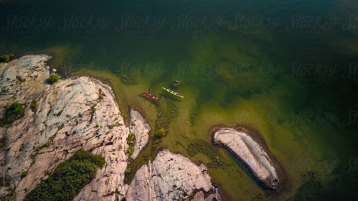 "Aerial Photo Of Paddlers Sea Kayaking On Camping Trip To Remote ...