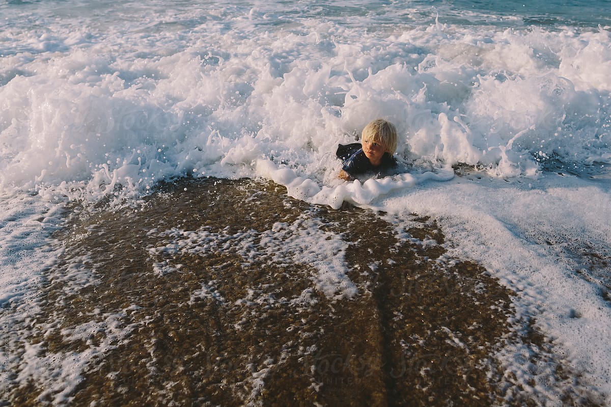 "Baby Girl Fallen Into The Wave" by Stocksy Contributor "Evgenij Yulkin ...