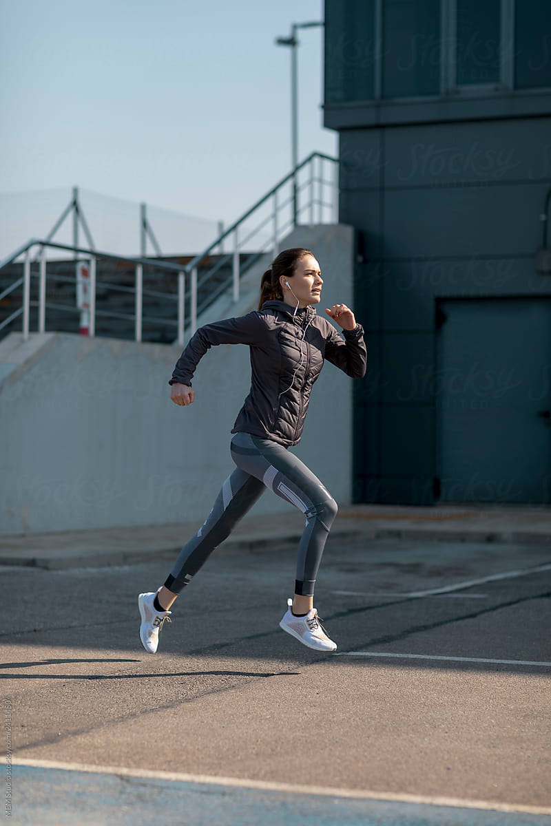 "Woman Running In Urban Environment" by Stocksy Contributor "MEM Studio ...