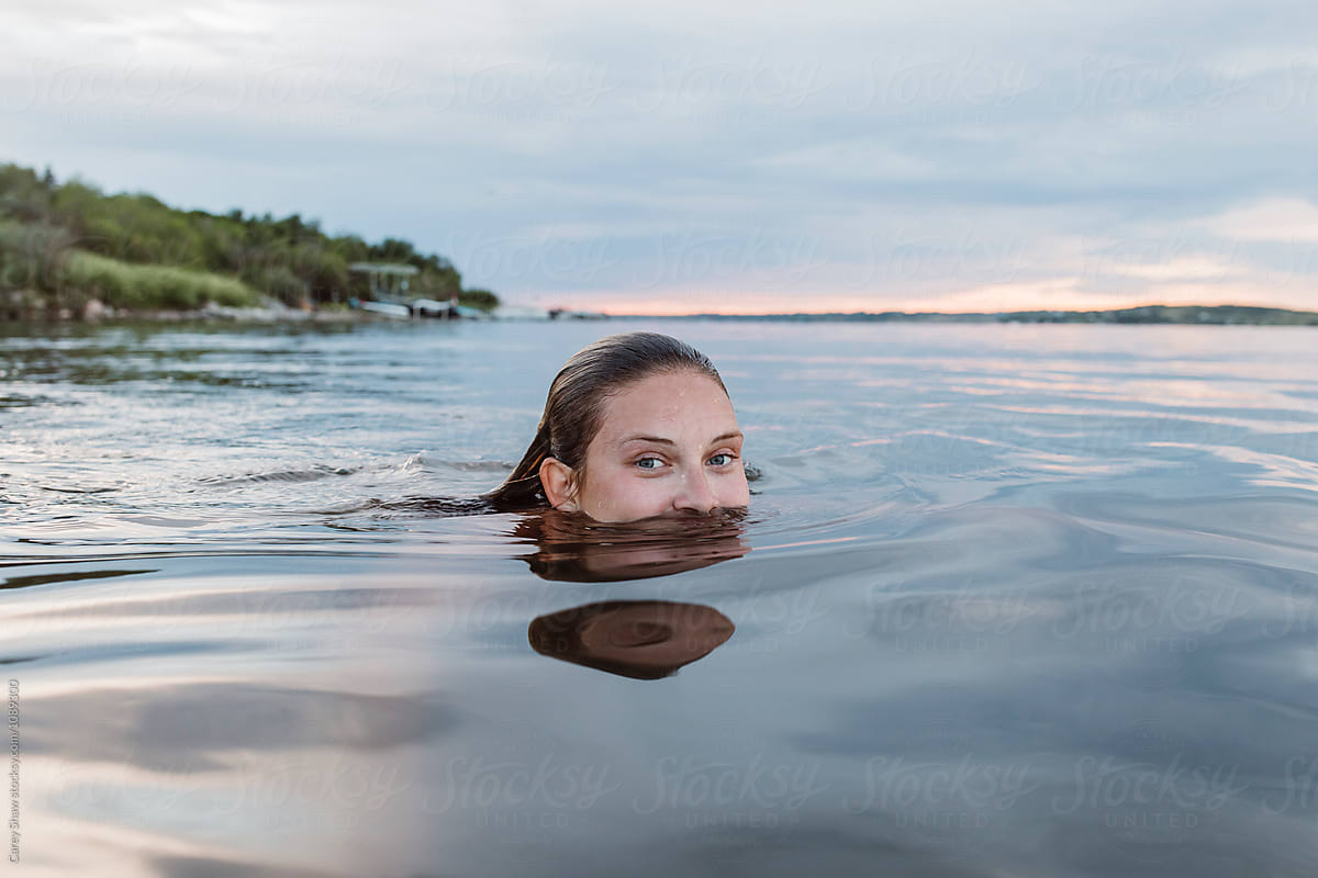 "Beautiful Young Woman Swimming In Lake At Dusk" by Stocksy Contributor ...