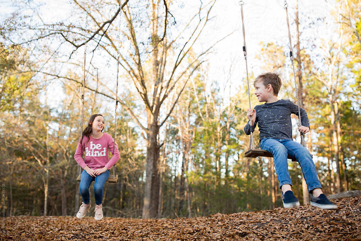 "Happy Kids Swinging" by Stocksy Contributor "Paige Stumbo" - Stocksy