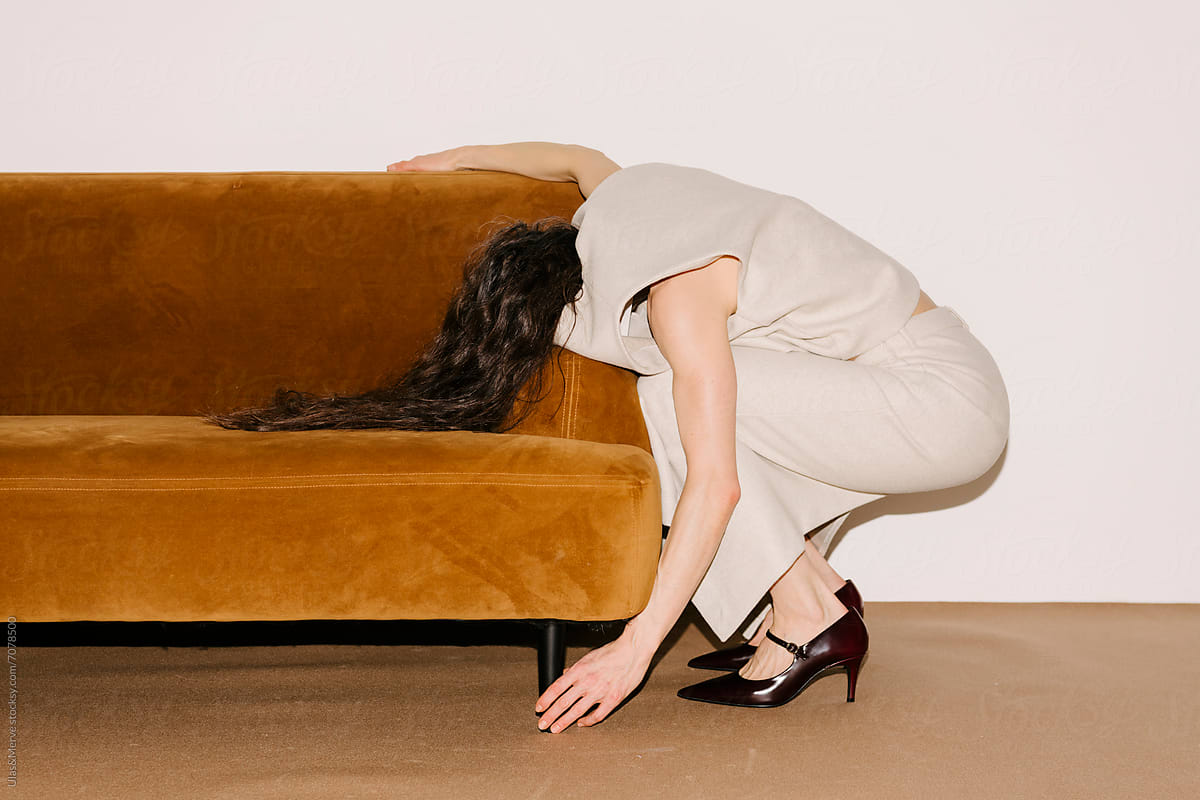 "Person Bending Over Couch In Beige Outfit" by Stocksy Contributor ...