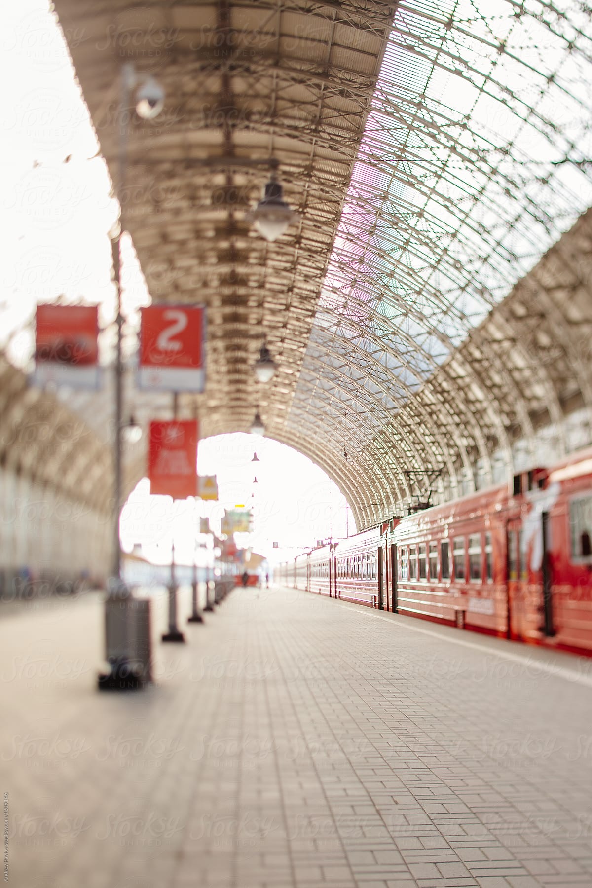 "Red Train Near Platform" by Stocksy Contributor "Andrey Pavlov" - Stocksy