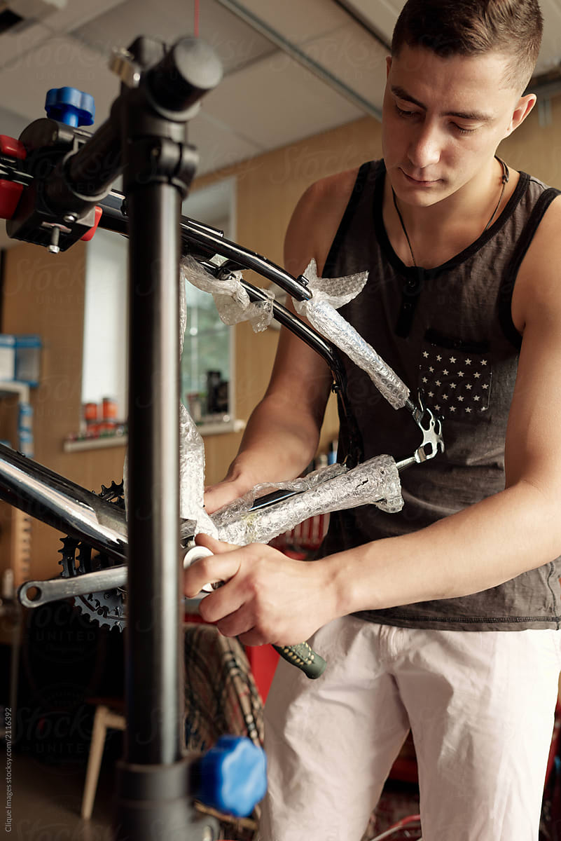 "Young Man Assembling Bike" by Stocksy Contributor "Clique Images ...