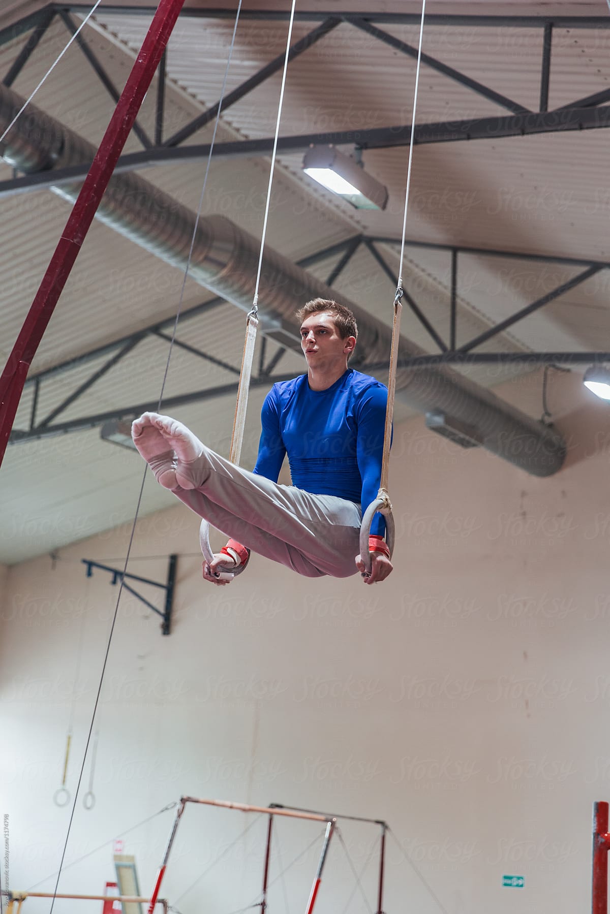 "Male Gymnast Holding Legs Perpendicular On Rings" by Stocksy ...