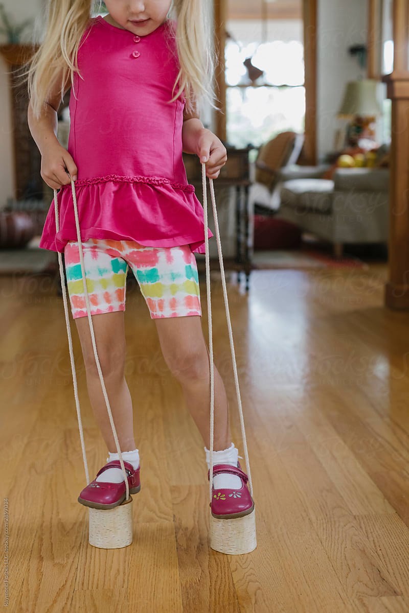 "Child Walking With Walking Stilts" by Stocksy Contributor "Raymond ...