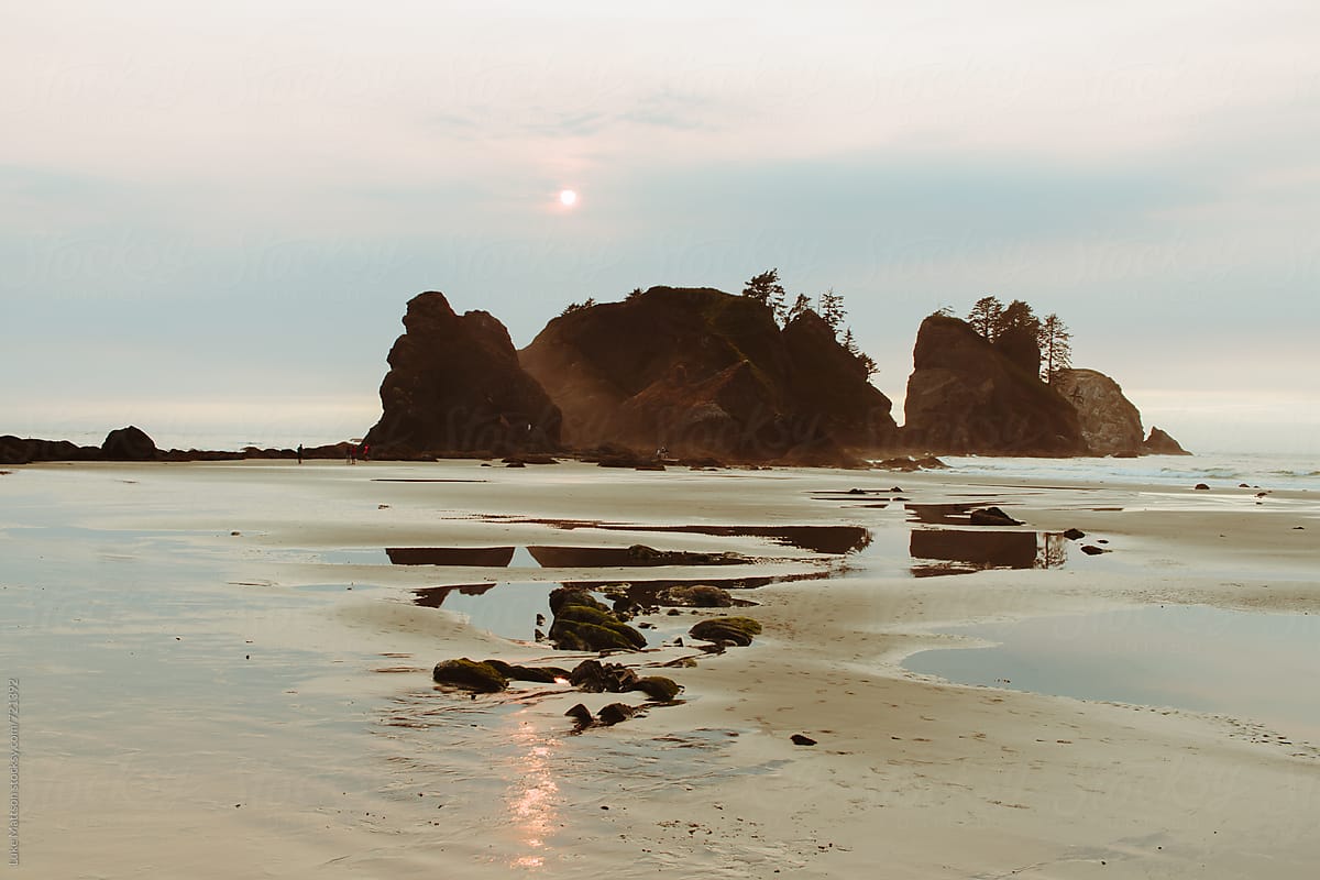 "The Sun Sets Over Rock Formations On The Shore Along The Washington ...