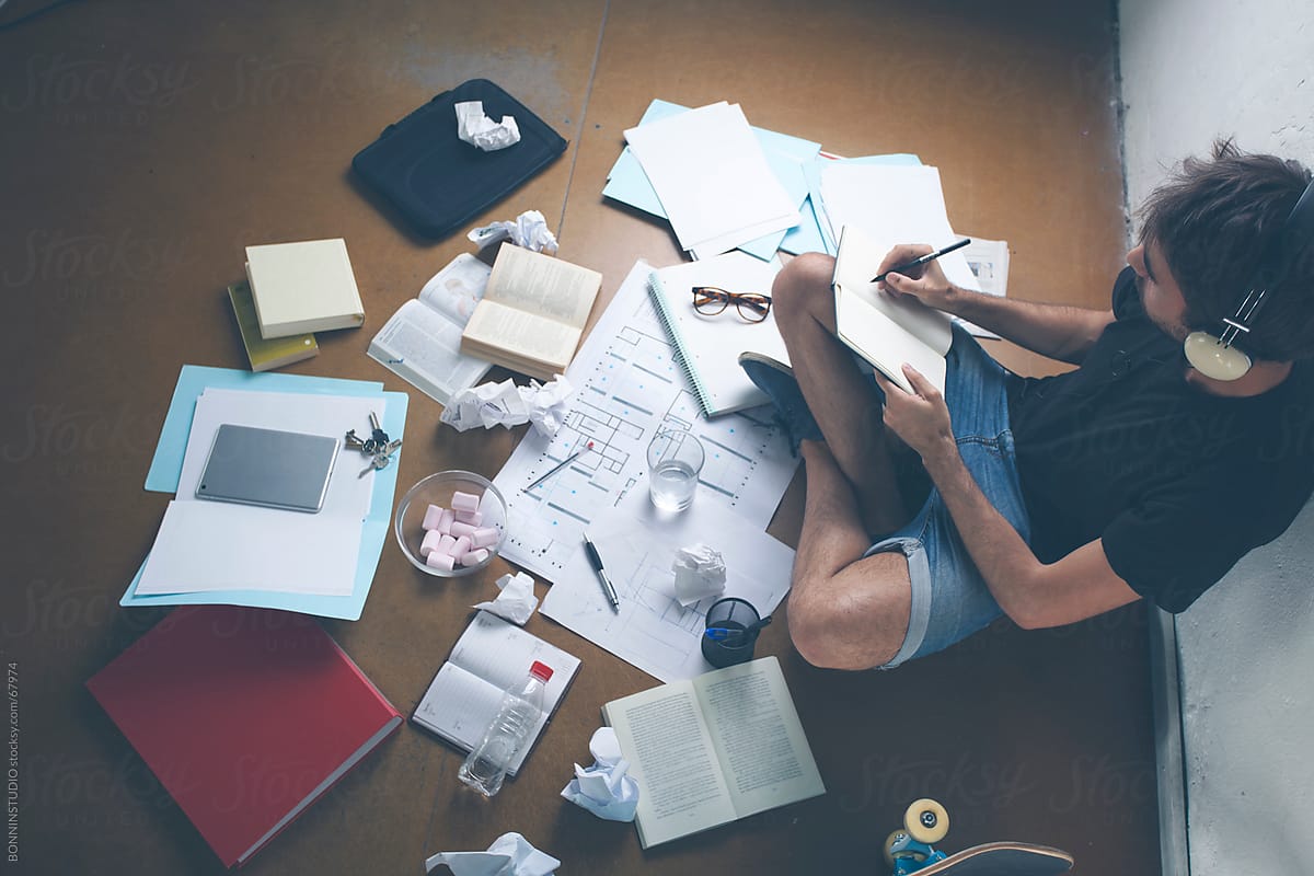 "Young Casual Man Studying With Notes And Books On The Floor." by ...