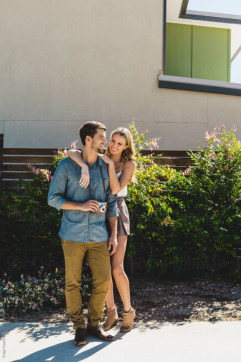 "Attractive Couple Standing Together Outside Taking Pictures." by ...