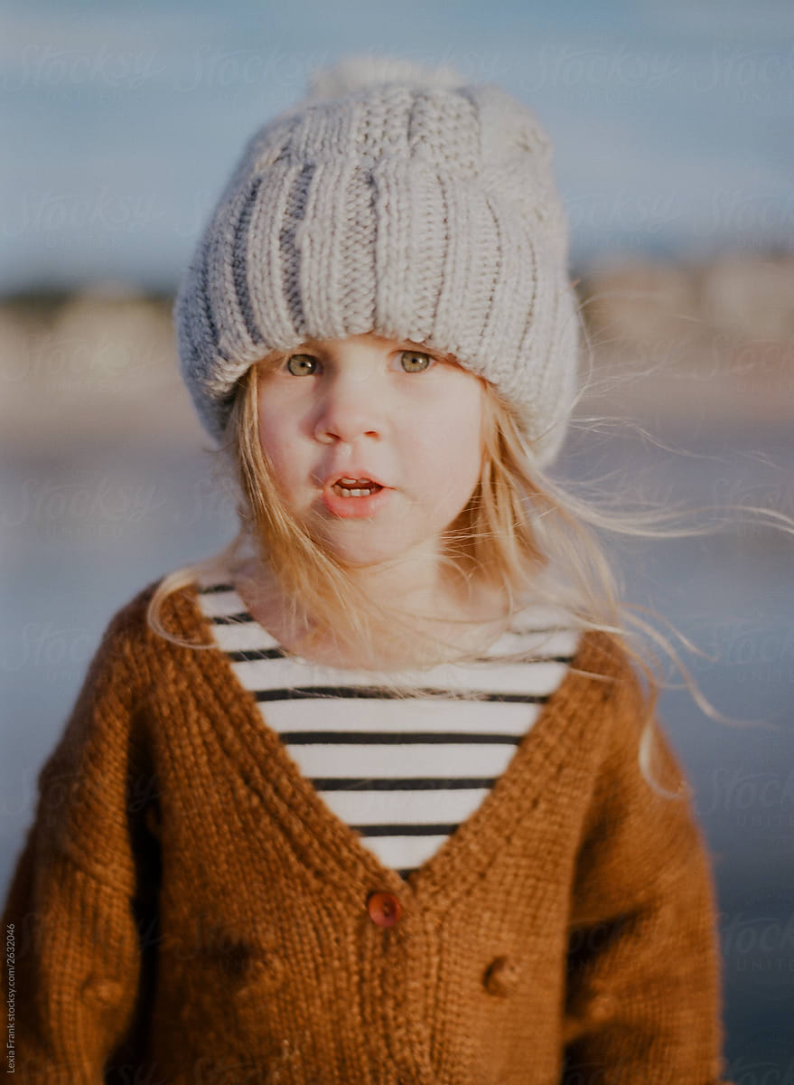 "Little Girl Portrait On The Chilly Coastal Beach" by Stocksy ...