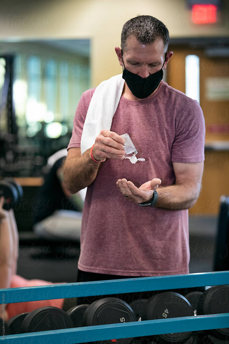 "Gym: Man Uses Hand Sanitizer While Working Out" by Stocksy Contributor ...