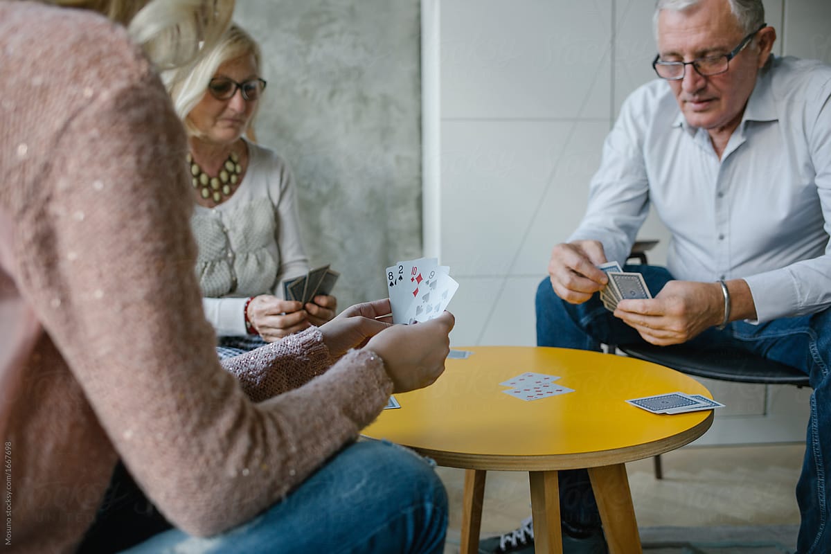 "Family At Home Playing Card Game" by Stocksy Contributor "Mosuno ...