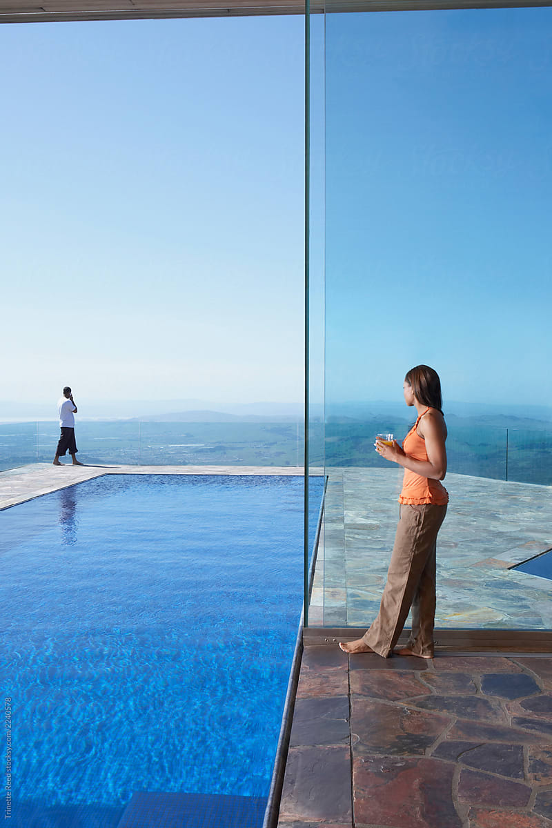 "Couple Relaxing Poolside At Luxury Rooftop Pool" by Stocksy ...