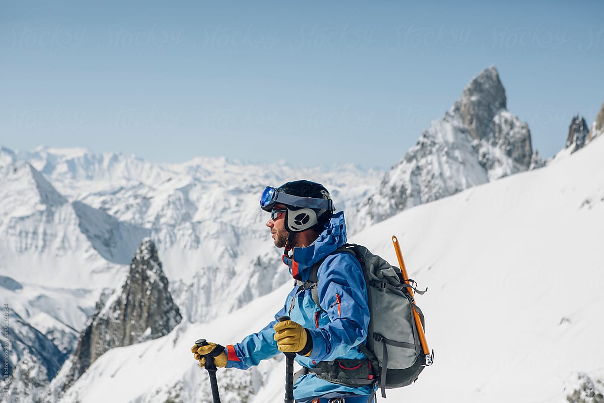 "Young Skier Looking Around To The Snowy Mountains" by Stocksy ...