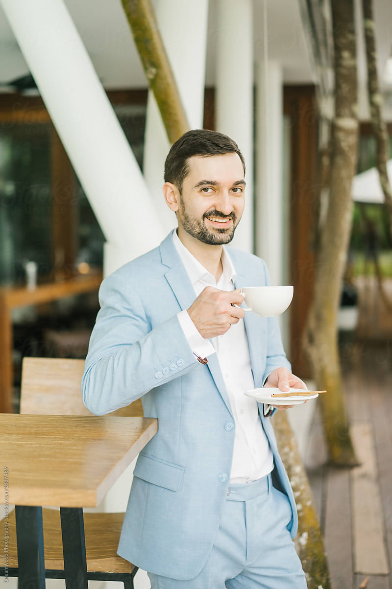 "Elegant Man In Suit Drinking Coffee" by Stocksy Contributor "Dreamwood ...