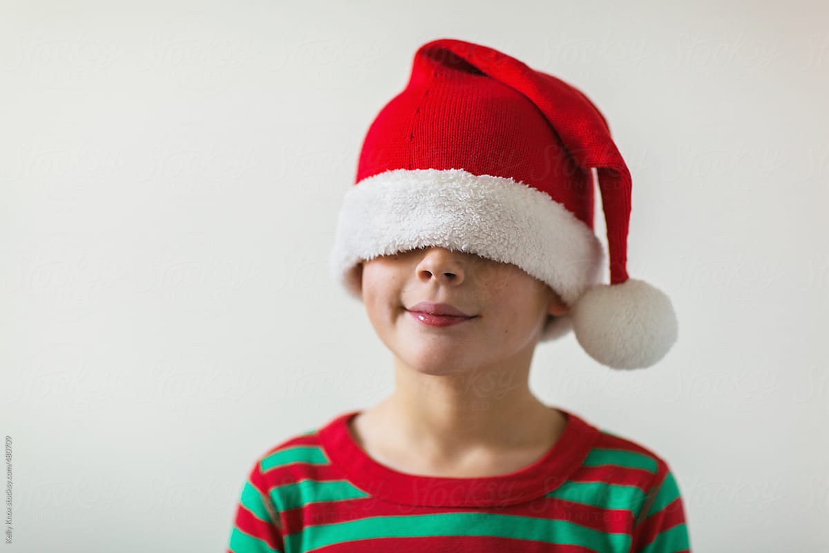 "Smiling Boy With A Santa Hat Pulled Over His Eyes" by Stocksy ...