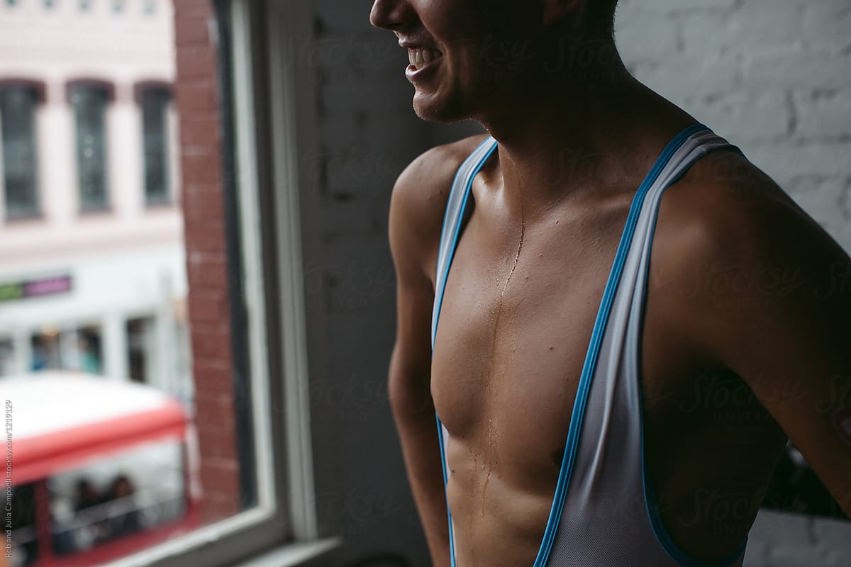 sweaty-young-man-training-on-indoor-stationary-bike-by-stocksy