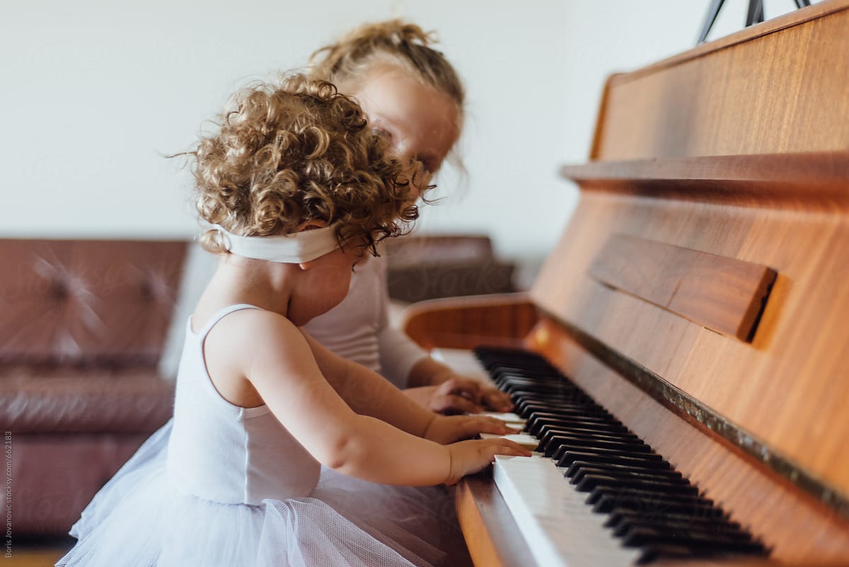 "Sisters Playing Piano" by Stocksy Contributor "Boris Jovanovic" - Stocksy