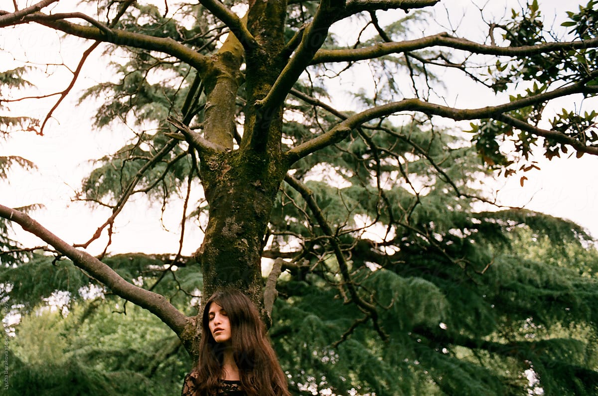 "Young Woman Standing Against The Tree" by Stocksy Contributor "Amor ...