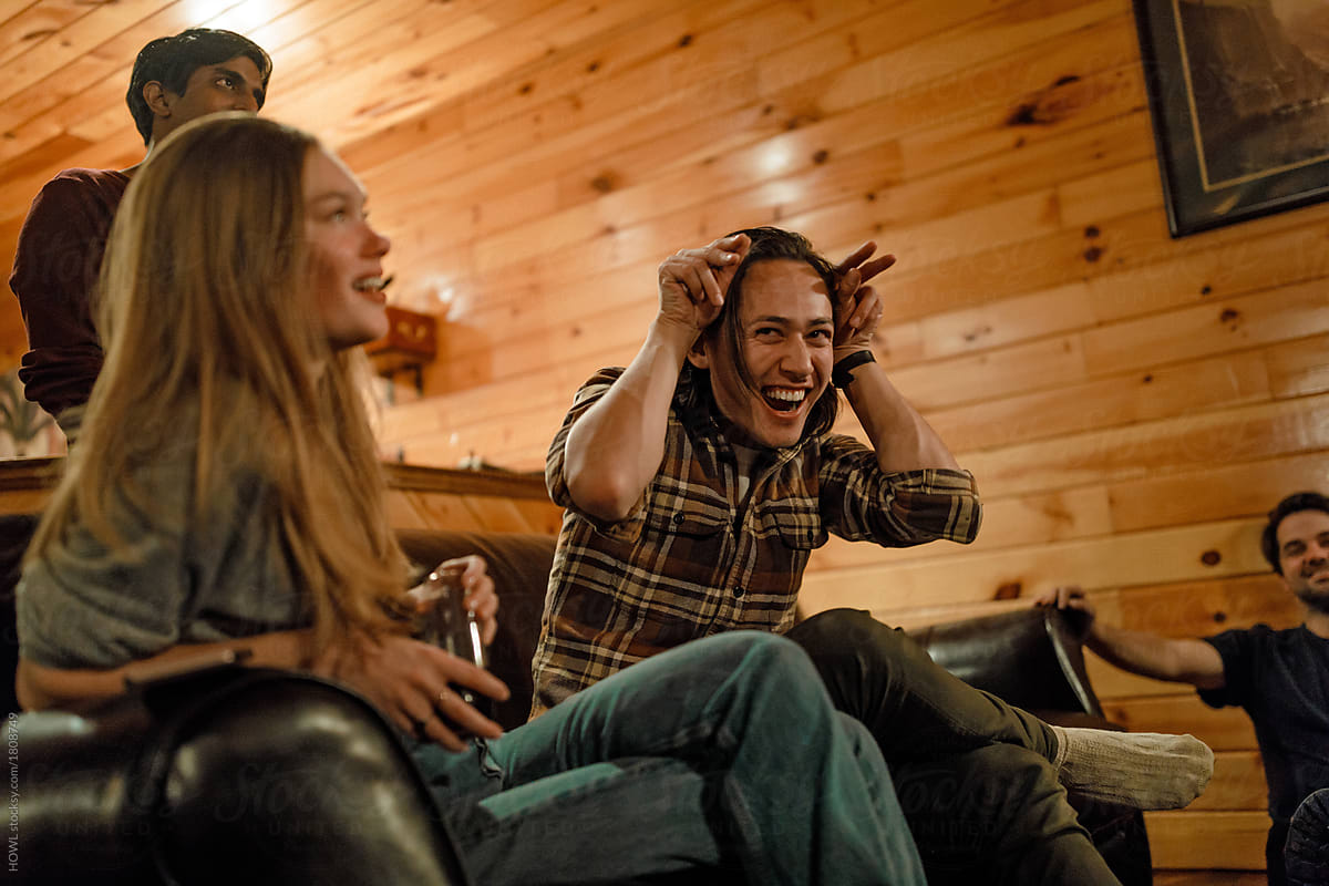 "Friends Laugh And Joke On A Couch In A Cabin In Upstate New York" by ...