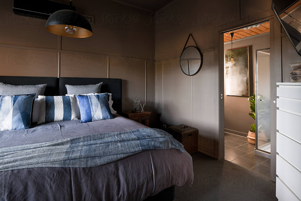 "Dark Styled Bedroom With Ensuite" by Stocksy Contributor "Rowena ...