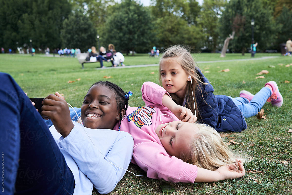 "Kids Lying On The Grass" by Stocksy Contributor "Ivan Gener" - Stocksy