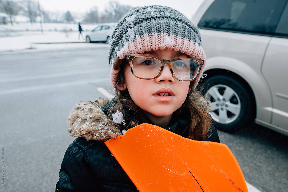 Girl Holding Sled In Parking Lot By Stocksy Contributor Jessica Girl Holding Sled In Parking Lot By Stocksy Contributor Jessica