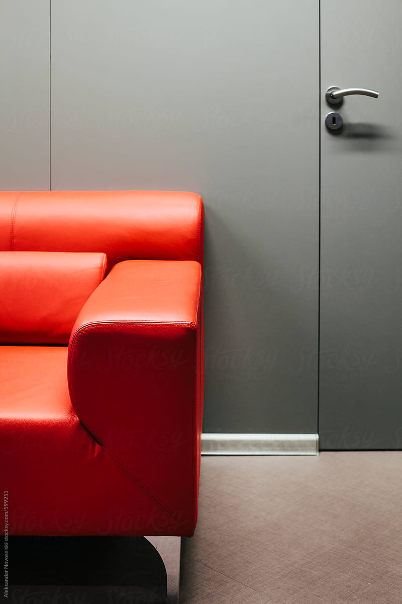 "Red Sofa In Modern Office" by Stocksy Contributor "Aleksandar ...