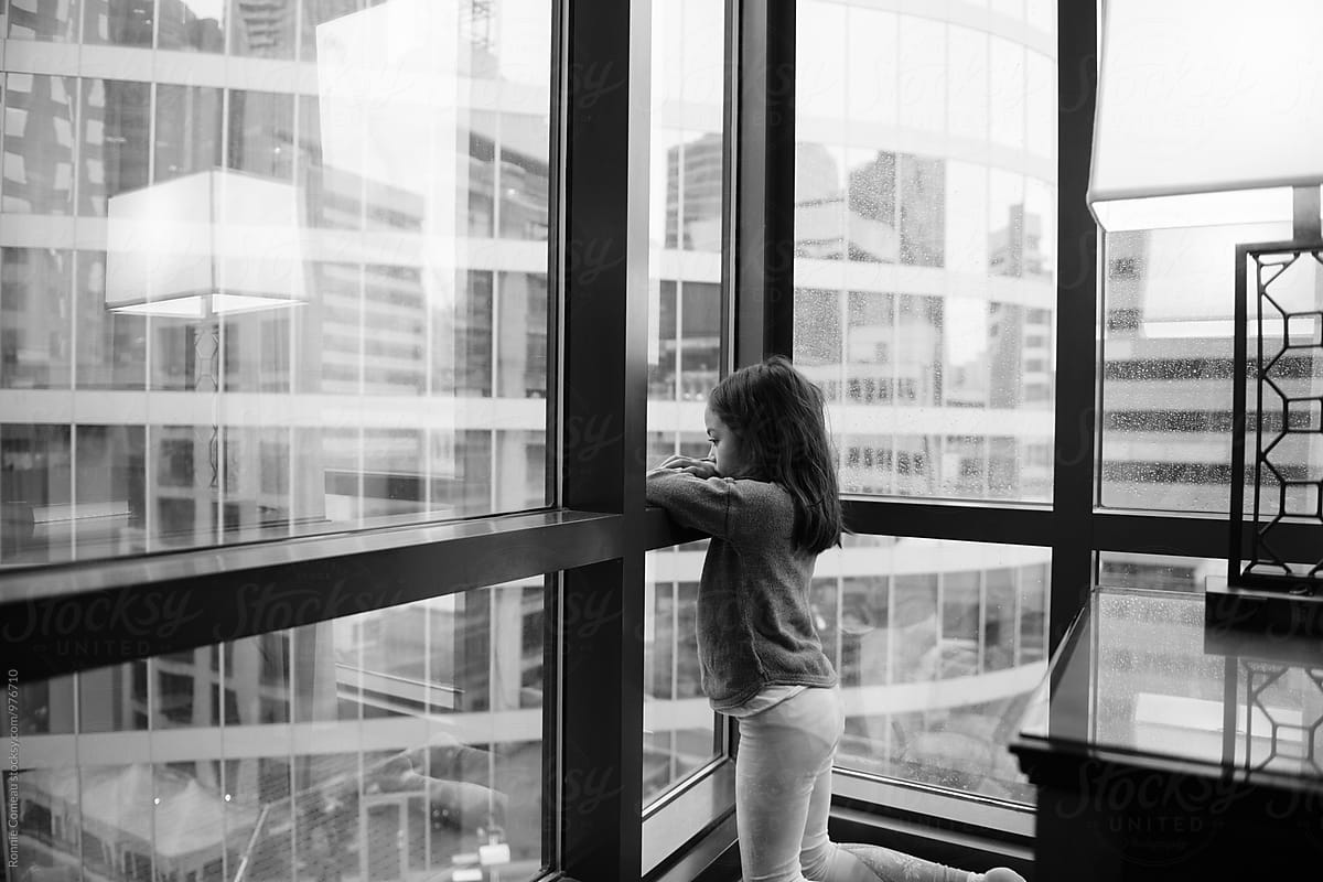 "Little Girl Looking Out Apartment Window" by Stocksy Contributor ...