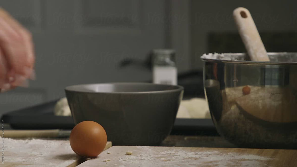 "Hands Crack Egg Into Bowl." by Stocksy Contributor "RZCREATIVE" - Stocksy