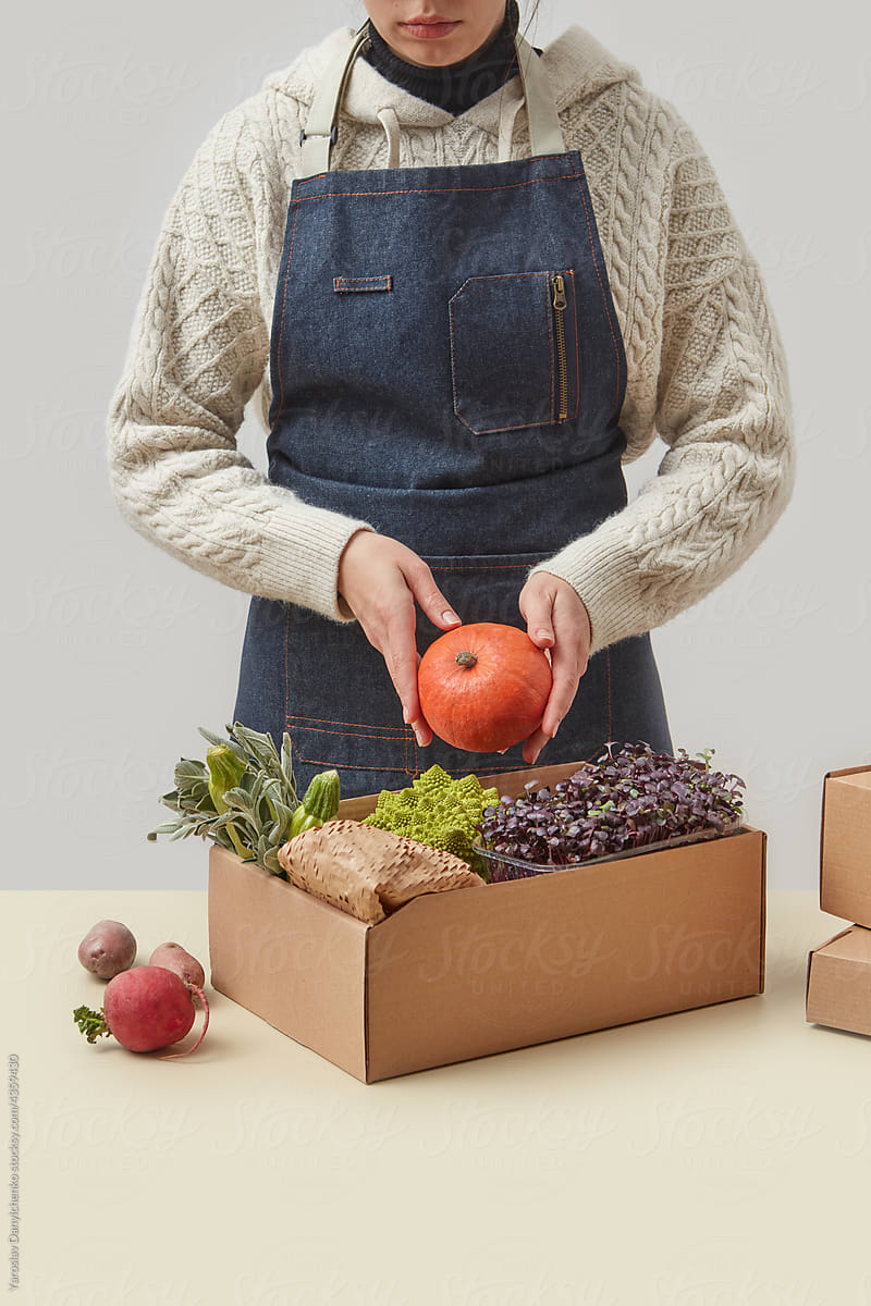 "Delivery Service Worker Packing Vegetables In Box" by Stocksy ...