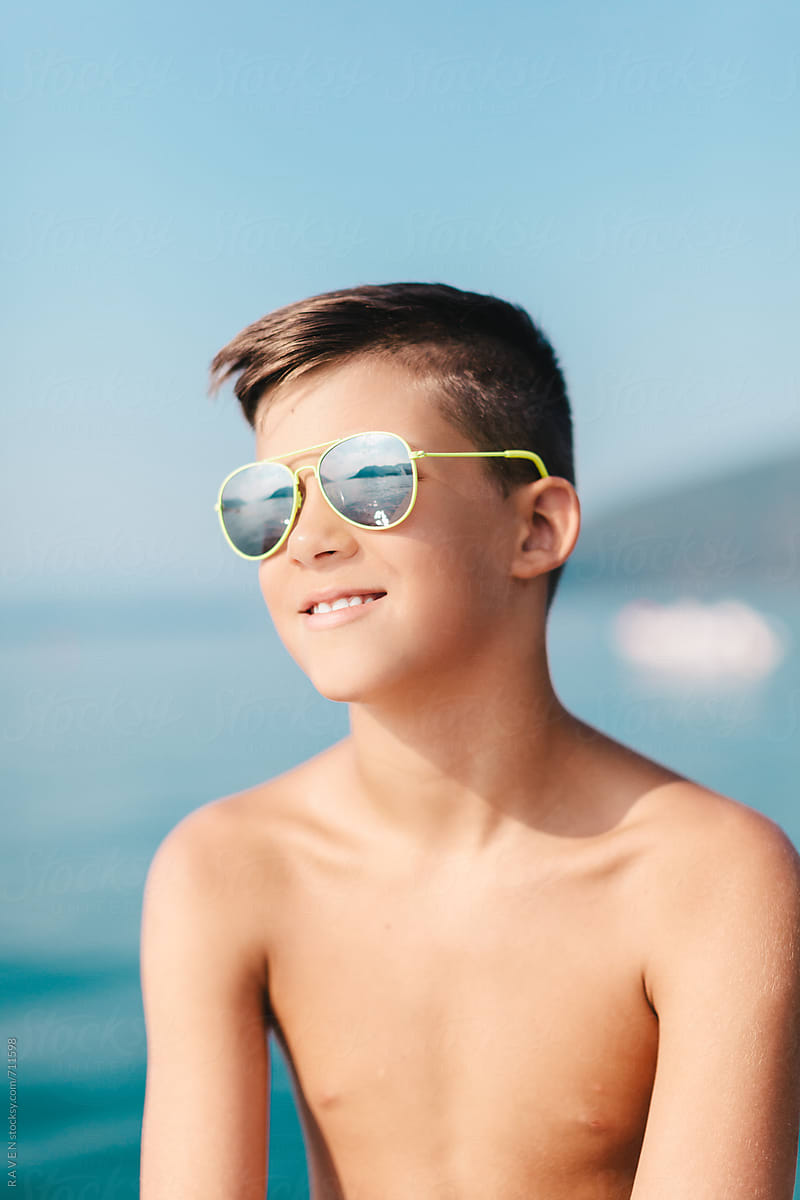 "Boy Sun Bathing" by Stocksy Contributor "Zoran Djekic" - Stocksy