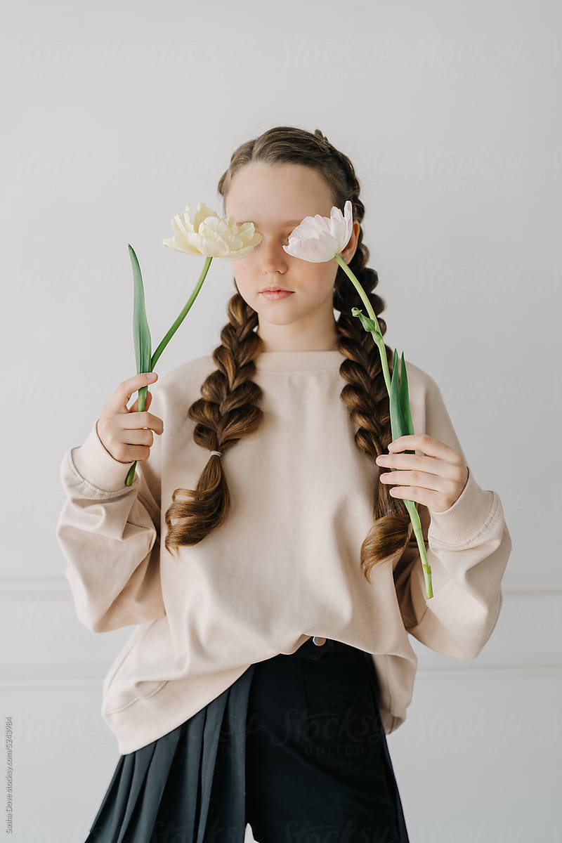 "Young Girl Holds Flowers In Front Of Her Face" by Stocksy Contributor ...
