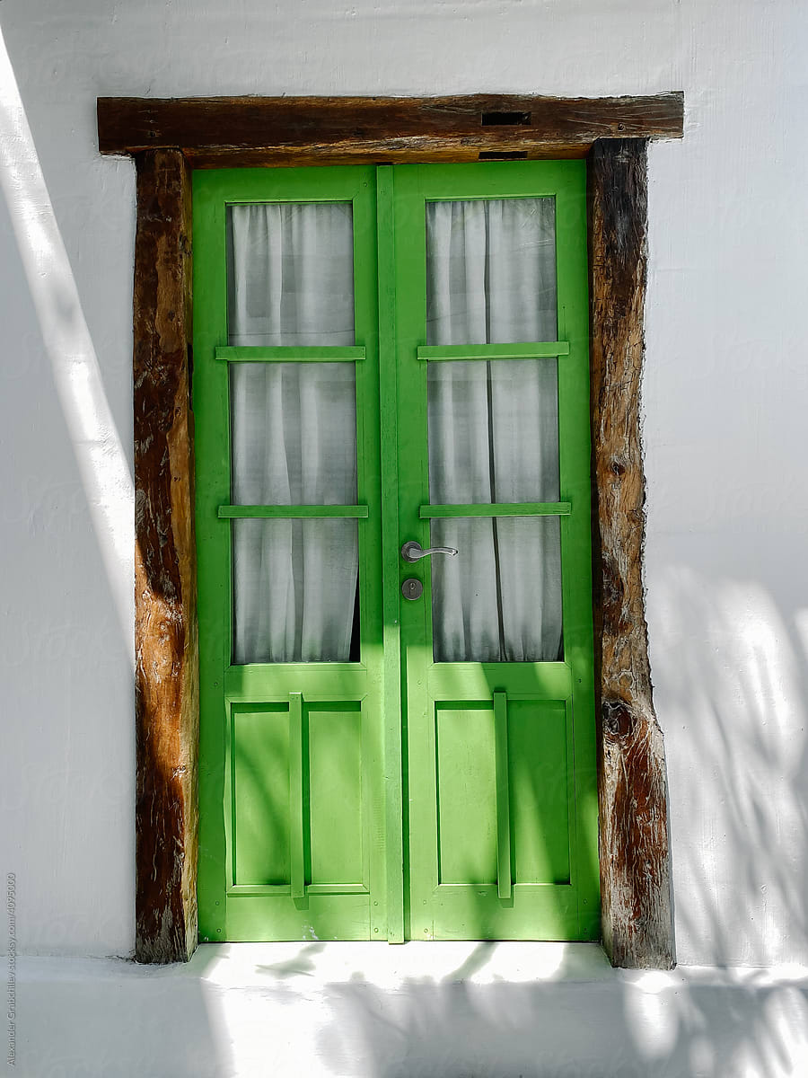 "Bright Green Wooden Door With Rustic Frame In Sunlit White Wall" by ...
