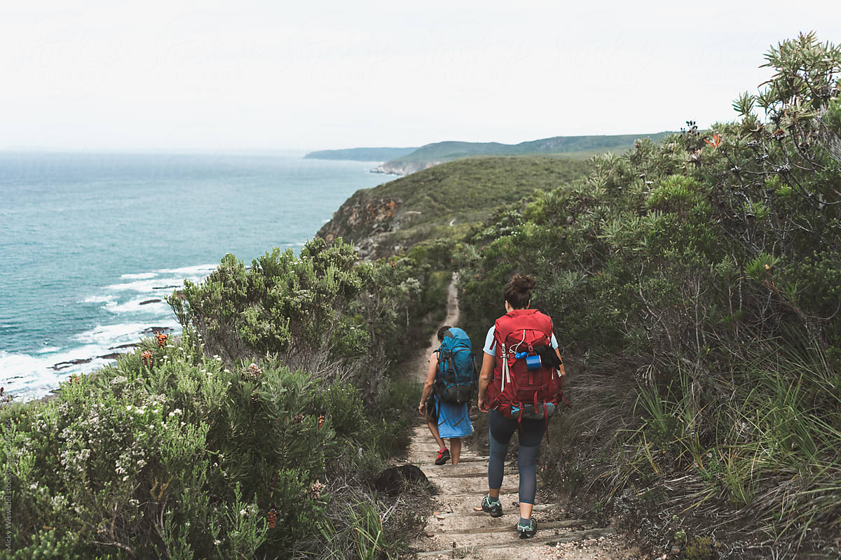 "Hiking On A Coastal Trail" by Stocksy Contributor "Juno" - Stocksy